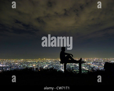 A horizontal shot of a city Osaka at night time crowded with people and ...