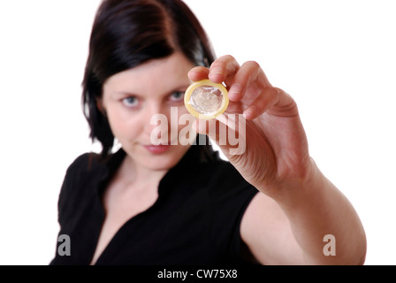 A young woman with a condom in her hand Stock Photo - Alamy