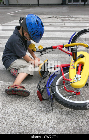 Accident Young child boy falling off a bicycle at BMX bike park on a ...