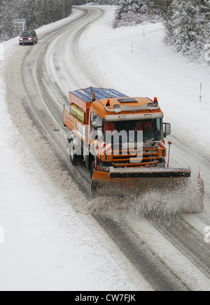 Cars and street covered by snow and snow plows try to combat the heavy ...