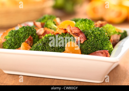 Homemade Broccoli Bacon Salad on a Plate on a black background, side ...