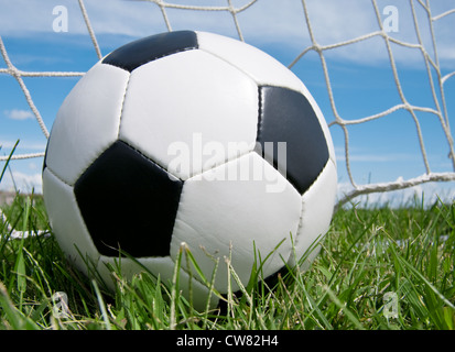 Classic football in the goal net Stock Photo - Alamy