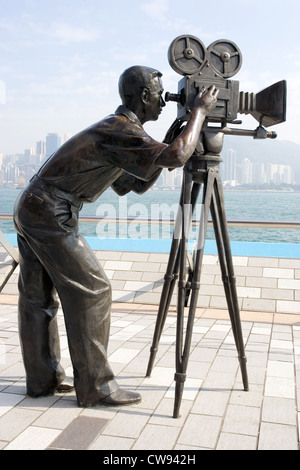 Vertical shot of a cameraman and a camera statue in a park during the ...
