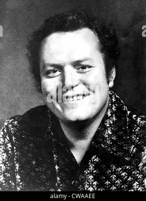 Hustler magazine publisher Larry Flynt drapes his leg over the arm of a ...