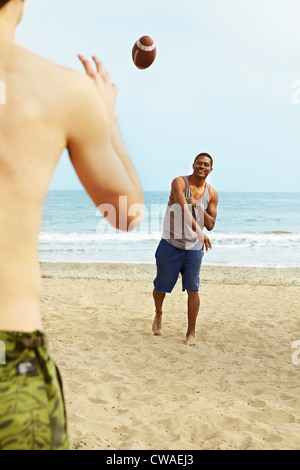 Playing rugby on the beach Stock Photo - Alamy