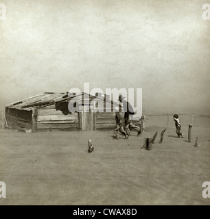 Storm in the Dust Bowl, America, 1930s. Man and boys walking towards ...