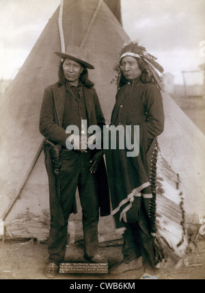 Three Cheyenne men wearing ceremonial clothing and holding rifles ...