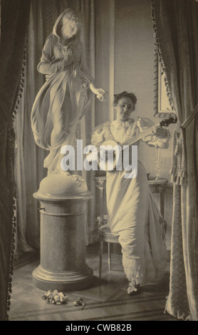 Miss Apperson playing banjo beside statue of 'Flora' in Sen. George ...