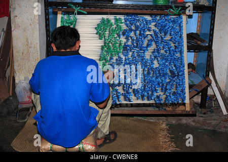 A process of Ikat fabric weaving. Preparing the thread for dyeing Stock ...
