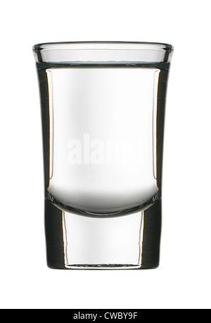 Shot glass of clear pure vodka on a reflective white surface with the ...