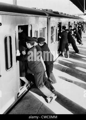 1960s, historical, Tokyo, Japan and commuters going up steps to enter a ...
