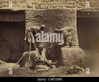 Using centuries old methods, men smelting iron ore in a primitive forge ...