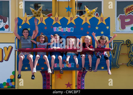 Fairground children; kids having fun on a fairground ride; Tivoli ...