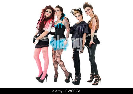 Portrait of all female rock band posing together over white background ...