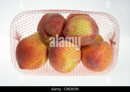 Spanish peaches in a plastic container frame covered by a red net Stock ...