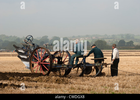 A balance plough being pulled by a cable from a Fowler Ploughing Engine ...