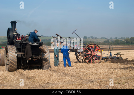 A balance plough being pulled by a cable from a Fowler Ploughing Engine ...