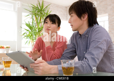 Young couple talking at dining table Stock Photo - Alamy