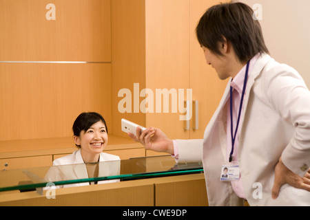 Businesswoman receiving visitor Stock Photo - Alamy