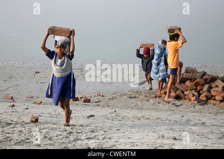 Child workers carry bricks carrying it on his head in Sonakhali, West ...