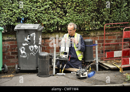 BT engineer working on cables in roadside cabinet Stock Photo: 18486632 ...