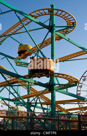 Fair with kiddie roller coaster ride Stock Photo - Alamy
