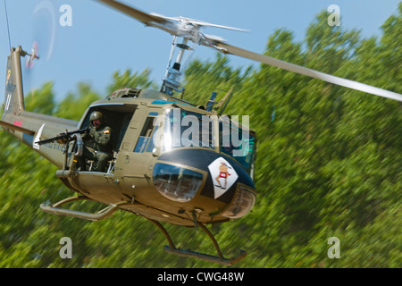 A restored Vietnam-era US Huey helicopter, equipped with an M60 MG ...