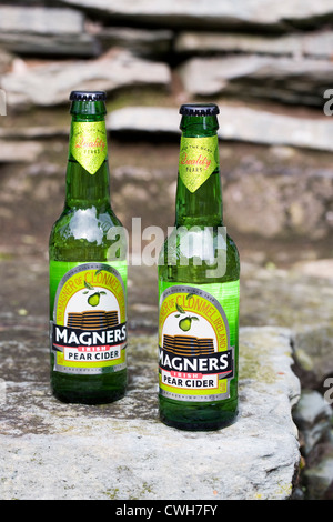 Bottles of Magners pear cider on a wooden table Stock Photo - Alamy