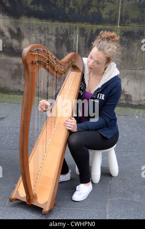 Woman street performer, harpist playing the harp, Dublin, Ireland ...