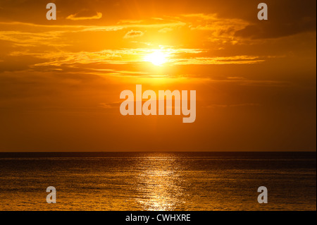 Sunrise in the sea with soft wave and cloudy Stock Photo - Alamy
