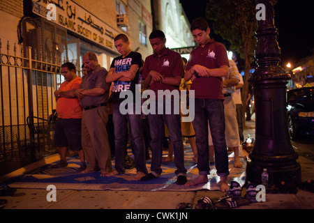 Muslim-American men perform prayers outside the Islamic Society of Bay ...