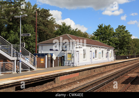 Looking across the tracks at an old station building with a wooden ...