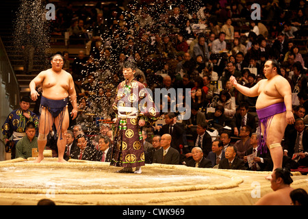 Some sumo fighters throwing salt before a fight at the Kokugikan ...
