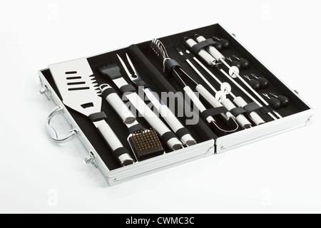 Silver case with barbecue cultery on white background Stock Photo - Alamy