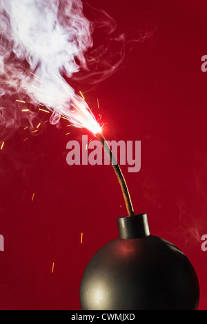 Old-fashioned explosive device ready to go off with hand holding ...