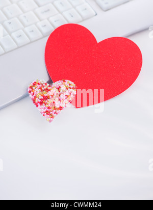 Paper hearts on computer keyboard Stock Photo - Alamy
