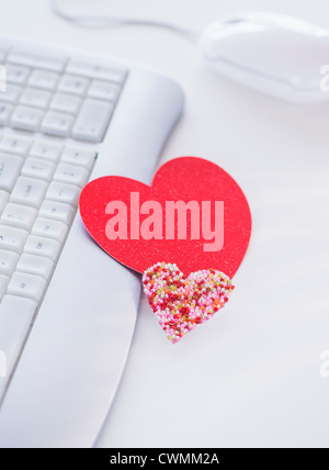 Paper hearts on computer keyboard Stock Photo - Alamy