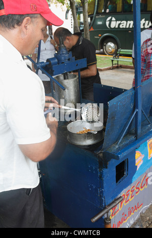 Man selling CHURROS on a street corner in Puebla, Mexico. Tasting a ...