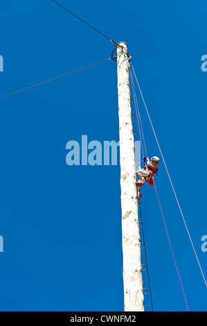 Portrait of girl climbing on pole at playground Stock Photo - Alamy
