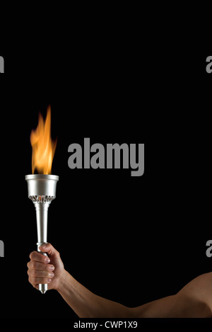Man's hand holding torch with no flame, cropped Stock Photo - Alamy
