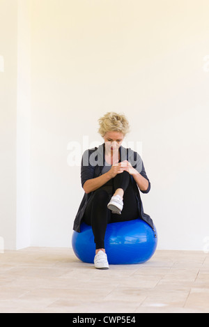 Woman hugging exercise ball Stock Photo - Alamy