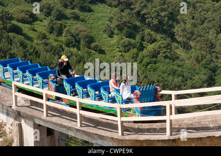Roller coaster ride female passengers above countryside of Northern ...