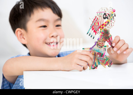 Chinese boy playing a Chinese traditional shadow puppet Stock Photo - Alamy