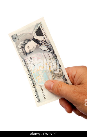 A male hand holding UK money, £5 pound, £10 pound and £20 pound notes ...