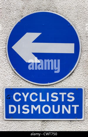 Cyclists Dismount sign notice on a footbridge over the River Sid at ...