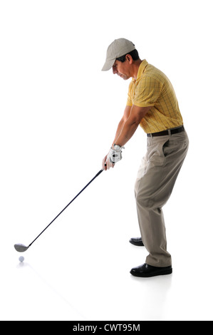 Man hitting golf ball while standing on field Stock Photo - Alamy