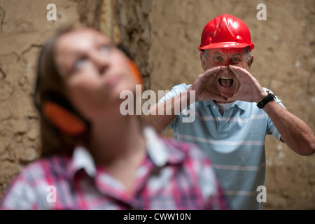 Construction worker yelling at colleague Stock Photo - Alamy