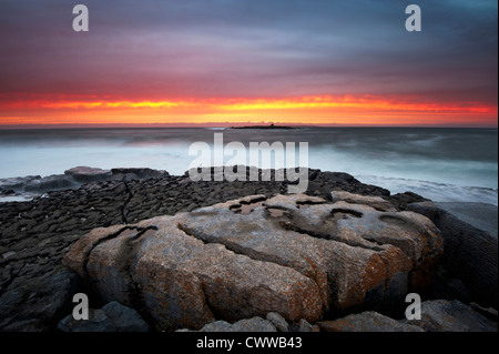 A long exposure image of the sea washing in around rocks at Porth Nobla ...