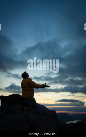 A man praying to God on the summit of a mountain Stock Photo - Alamy