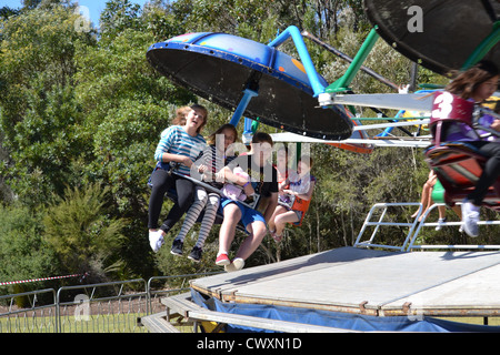 Children on the "Alien Invader" ride at carnival Stock Photo - Alamy